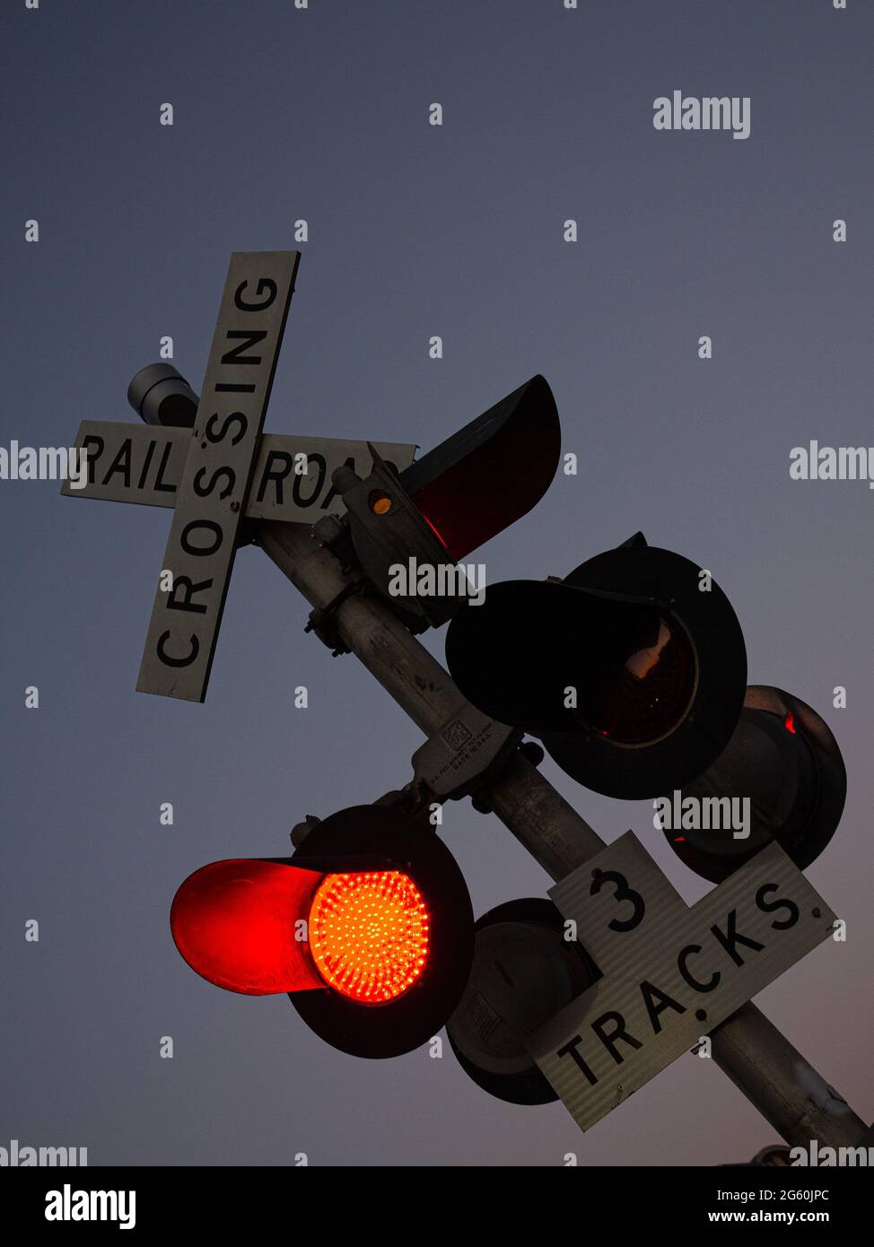 Railroad crossing with red light Stock Photo - Alamy