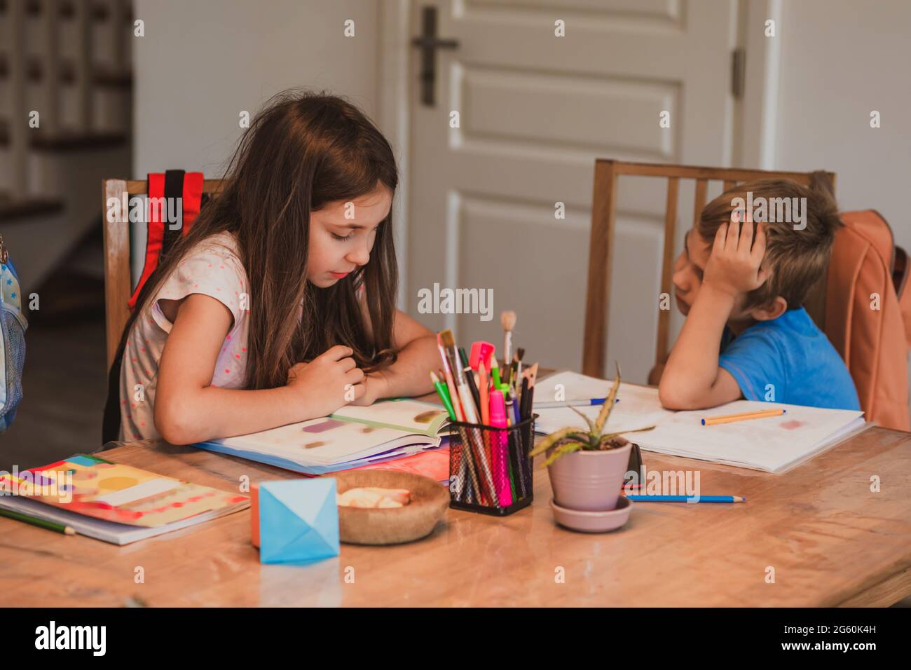 The schoolchildren are doing their homework together at home Stock ...