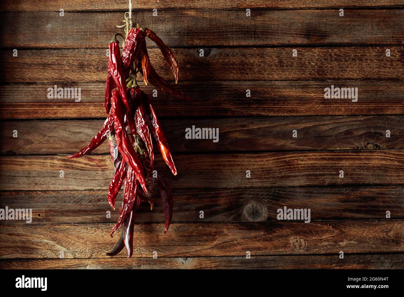 Dried red hot chili pepper on an old wooden background Stock Photo - Alamy