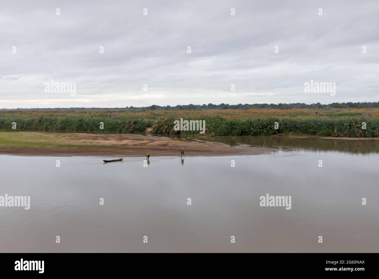 Local people stand in the shallow water of the Rufiji River Stock Photo ...