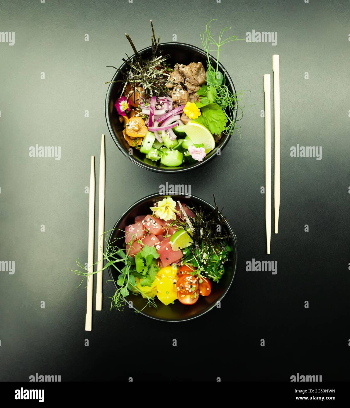 Poke salads with tuna and beef in bowls on the table. Two bowls of poke ...