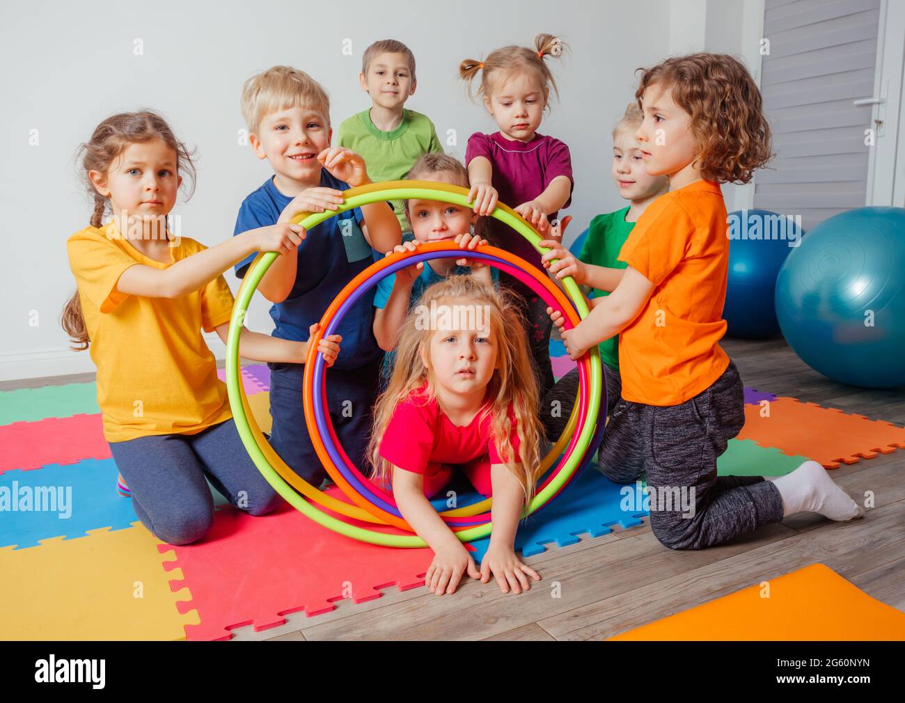 Portrait of smiling children with hula hoops Stock Photo - Alamy