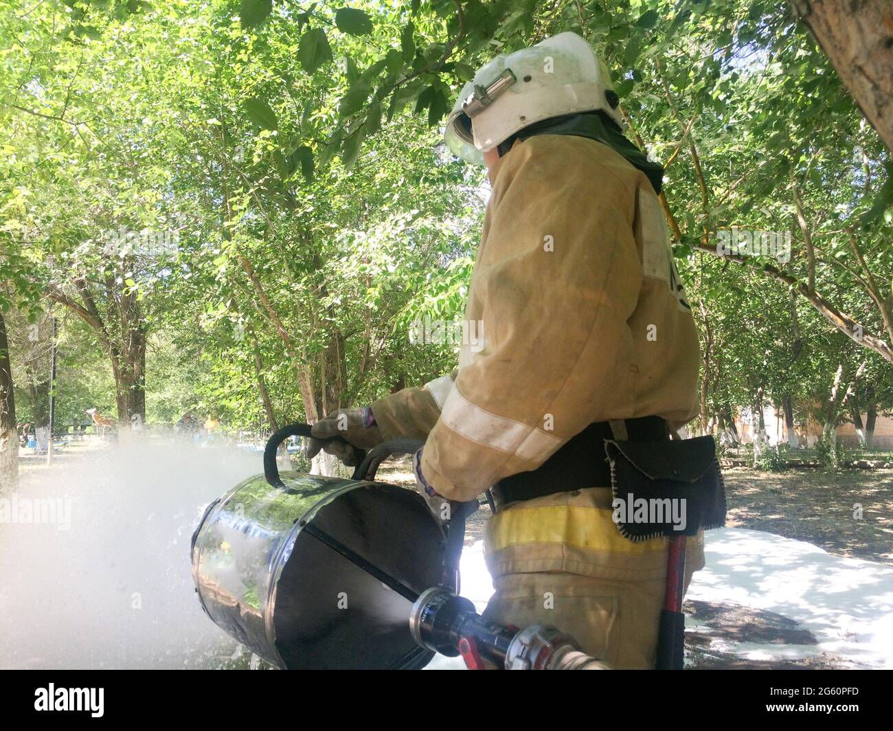 A firefighter releases a stream of foam from a hose Stock Photo - Alamy