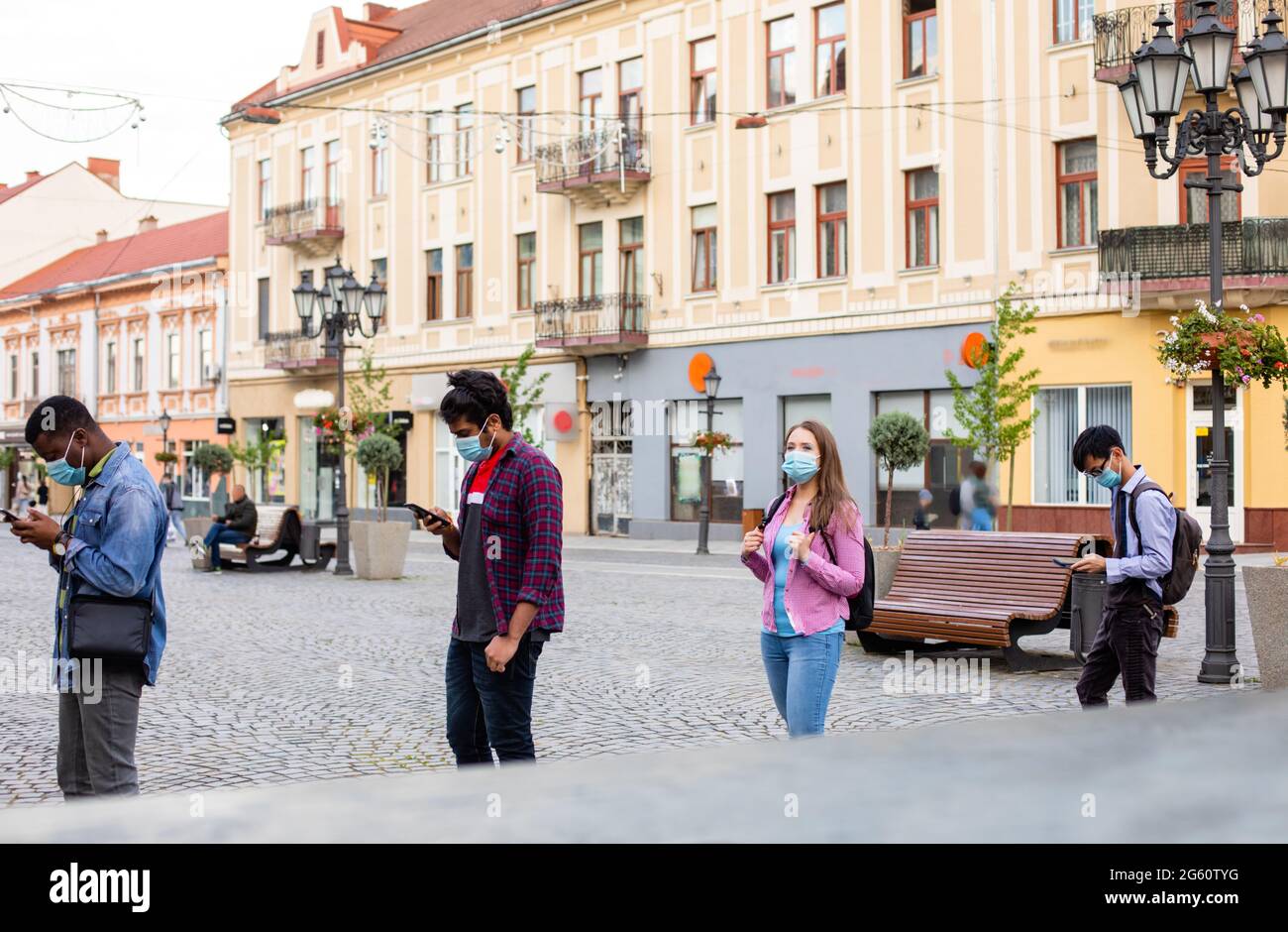 People in masks stand queue keeping social distance Stock Photo - Alamy