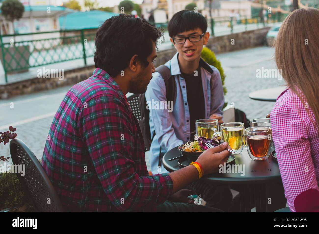 Multiracial group of friends having lunch together Stock Photo - Alamy