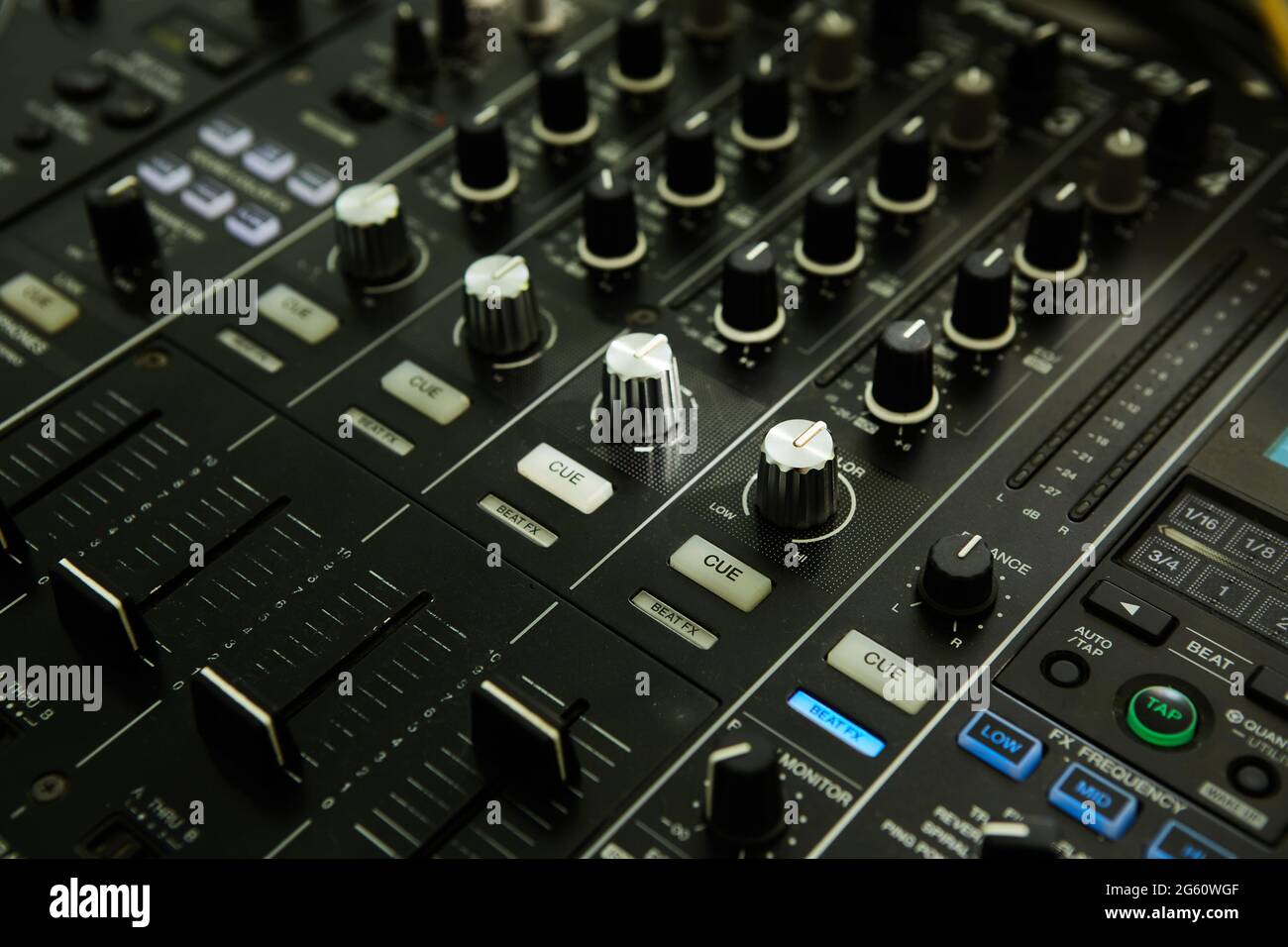 Wide angle photo of black sound mixer controller with knobs and sliders ...