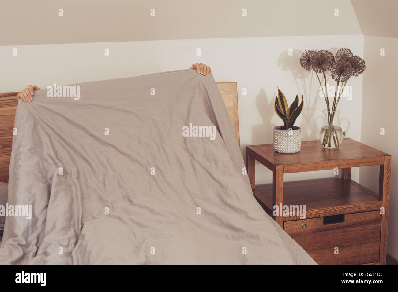Unrecognisable hands holding outstretched blanket over head Stock Photo ...