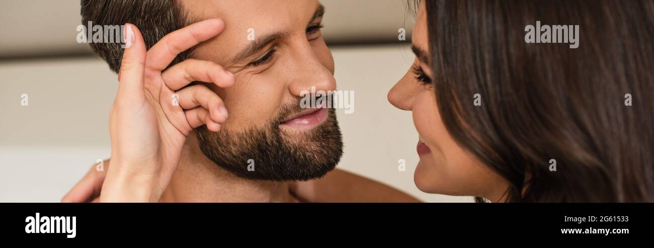 Smiling woman touching face of boyfriend at home, banner Stock Photo ...