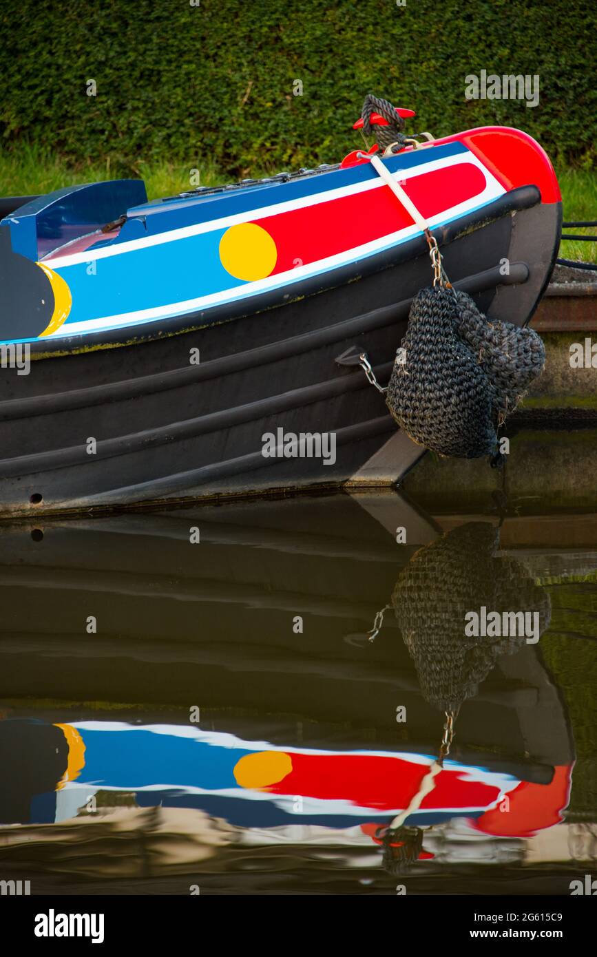 Colourful reflections of a narrowboat in the Leeds to Liverpool canal ...