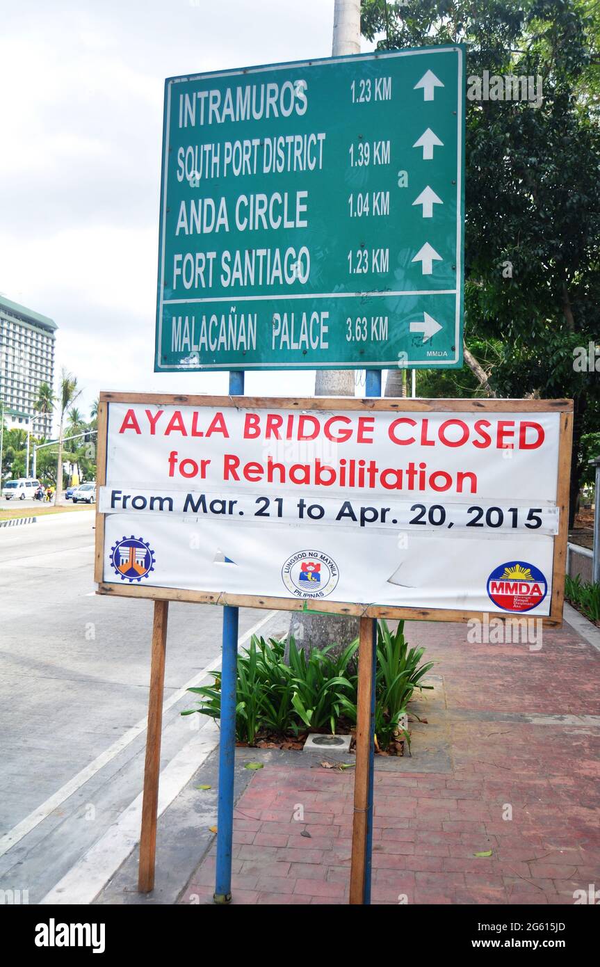 Direction guide signpost beside road on street for filipino people and ...