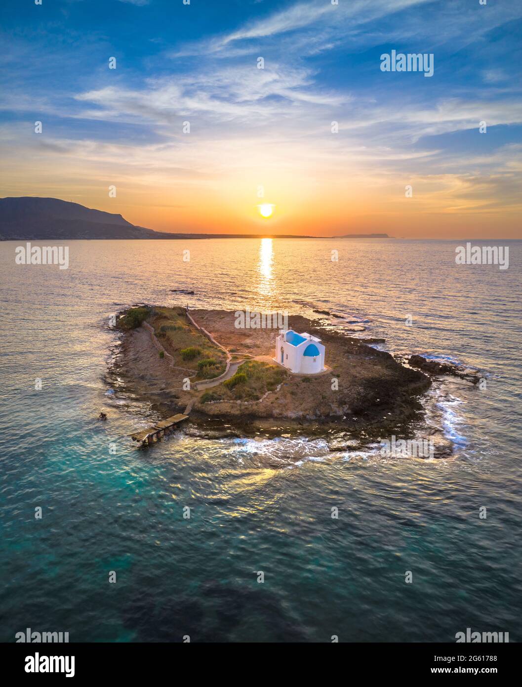 An old white church in a small island at sunset in Malia, Crete, Greece ...