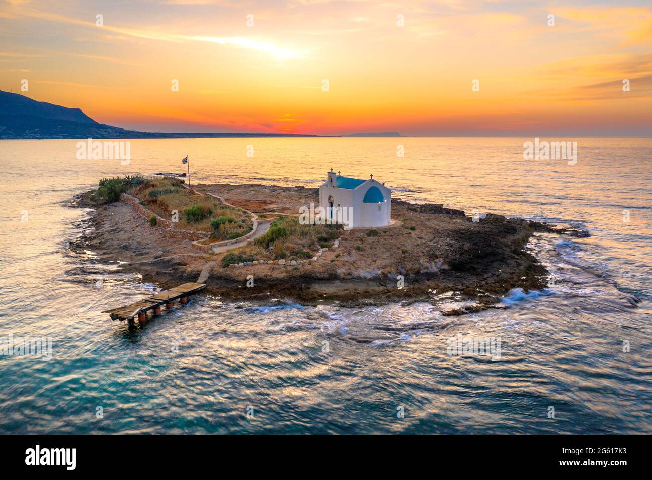 An old white church in a small island at sunset in Malia, Crete, Greece ...