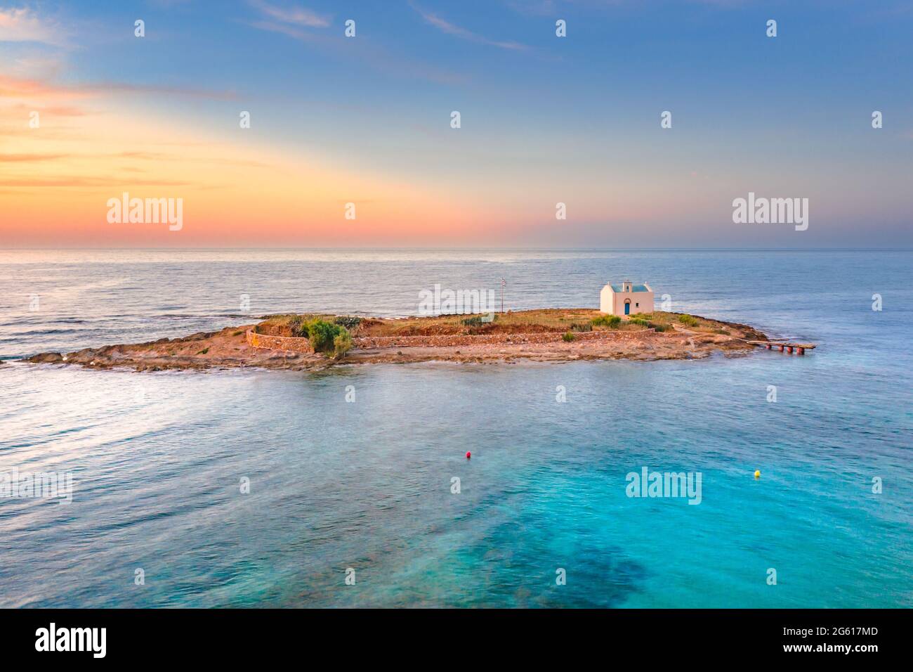 An old white church in a small island at sunset in Malia, Crete, Greece ...