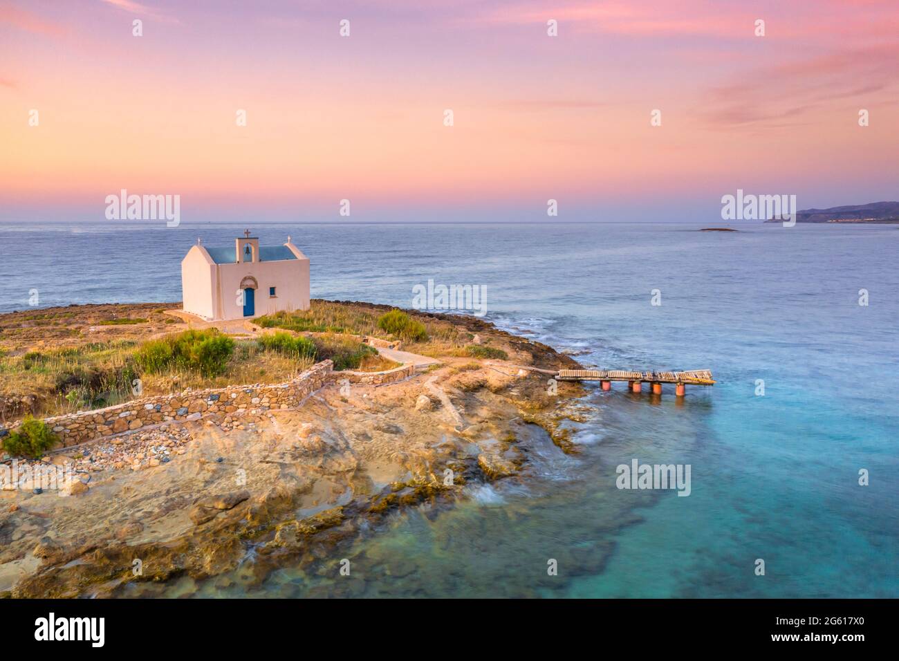 An old white church in a small island at sunset in Malia, Crete, Greece ...