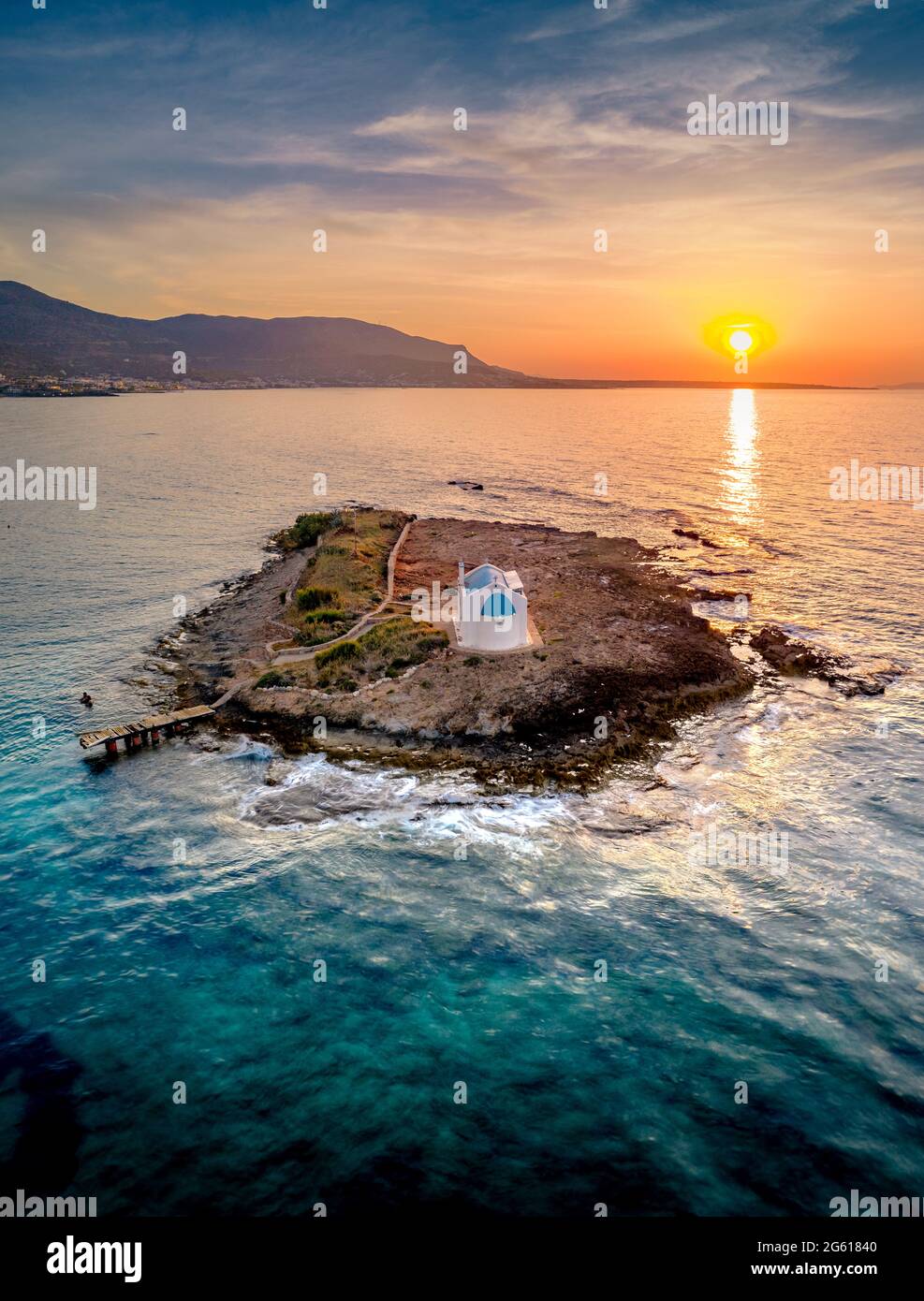 An old white church in a small island at sunset in Malia, Crete, Greece ...