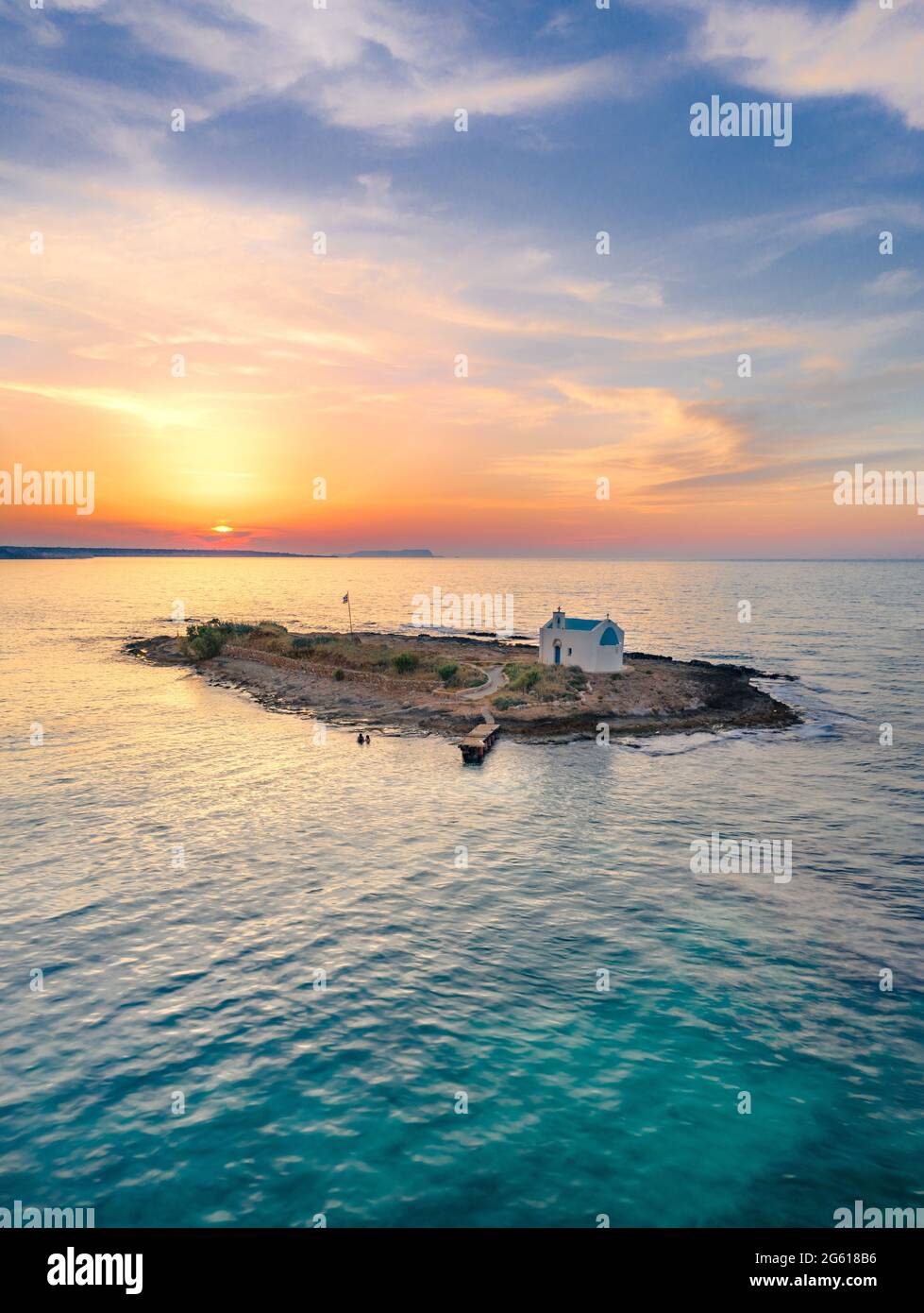 An old white church in a small island at sunset in Malia, Crete, Greece ...