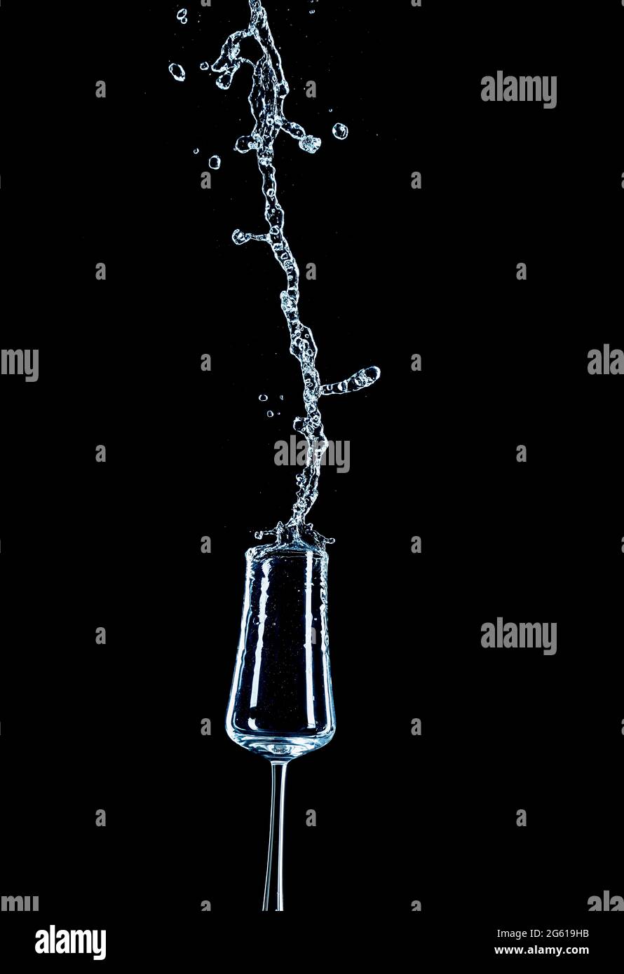 Water splash with inverted glass and black background Stock Photo - Alamy