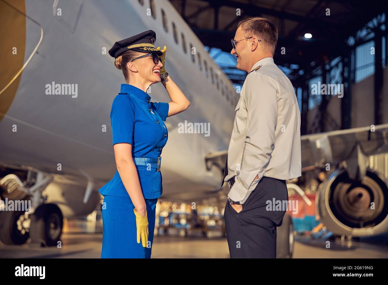 Captain talking with stewardess near the big passenger airplane Stock ...