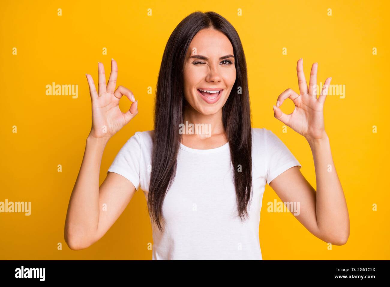 Photo of young girl wink eye happy excited show okey sign deal cool ...