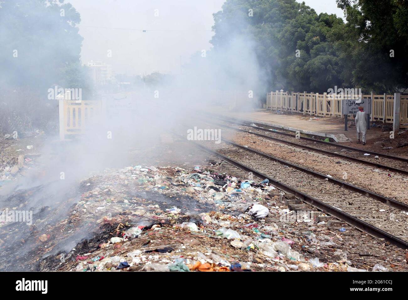 Smoke rising from burning huge heap of garbage, creating unhygienic ...