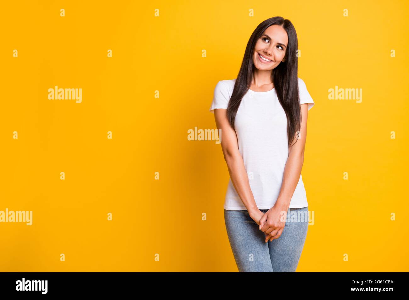 Photo portrait of cute brunette smiling looking at blank space isolated ...