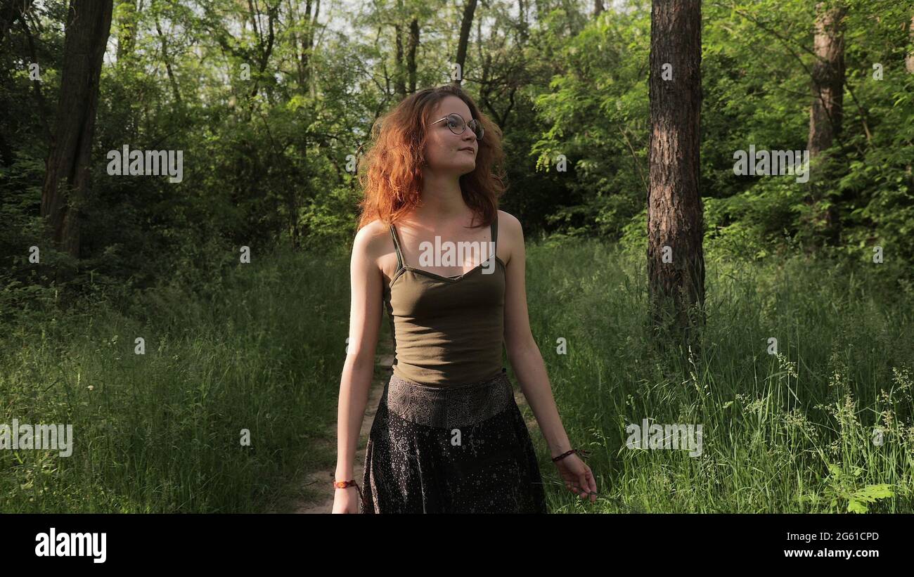Girl walking on a forest path Stock Photo - Alamy