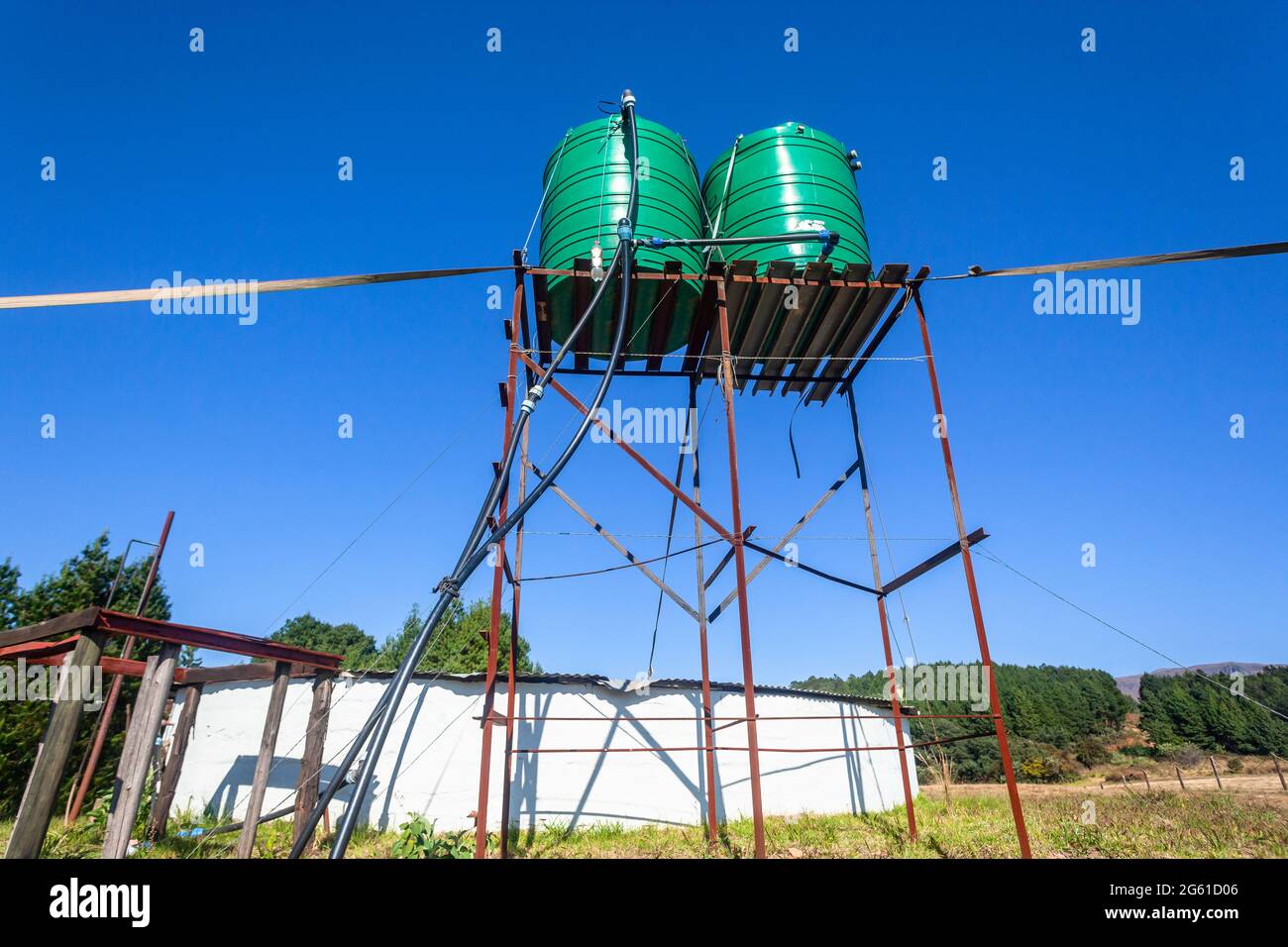 Forest Farm with two Large green colored water tanks on tall steel ...
