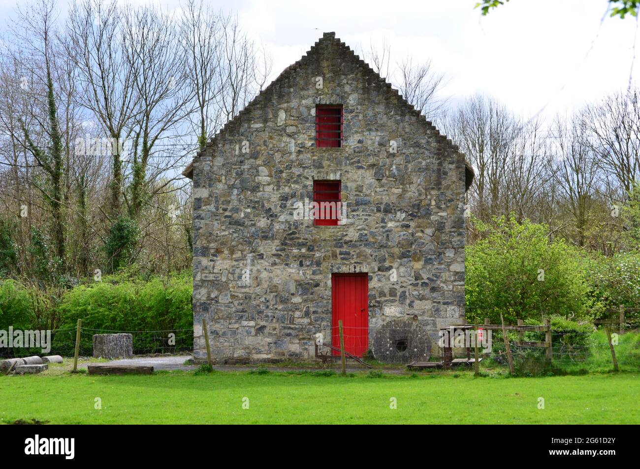 Bright red door on an old stone barn in Ireland Stock Photo - Alamy