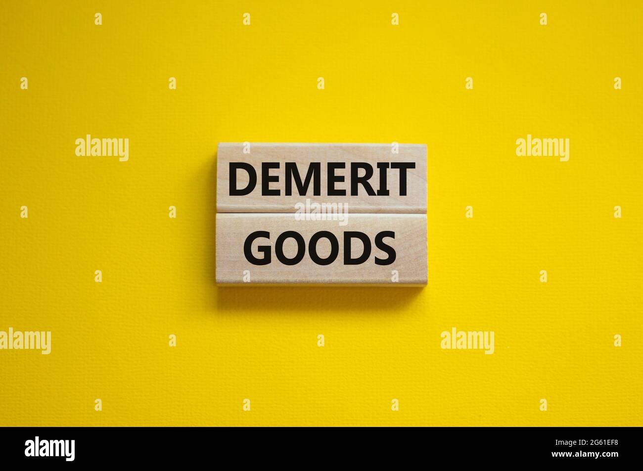 Demerit goods symbol. Wooden blocks with words Demerit goods on ...