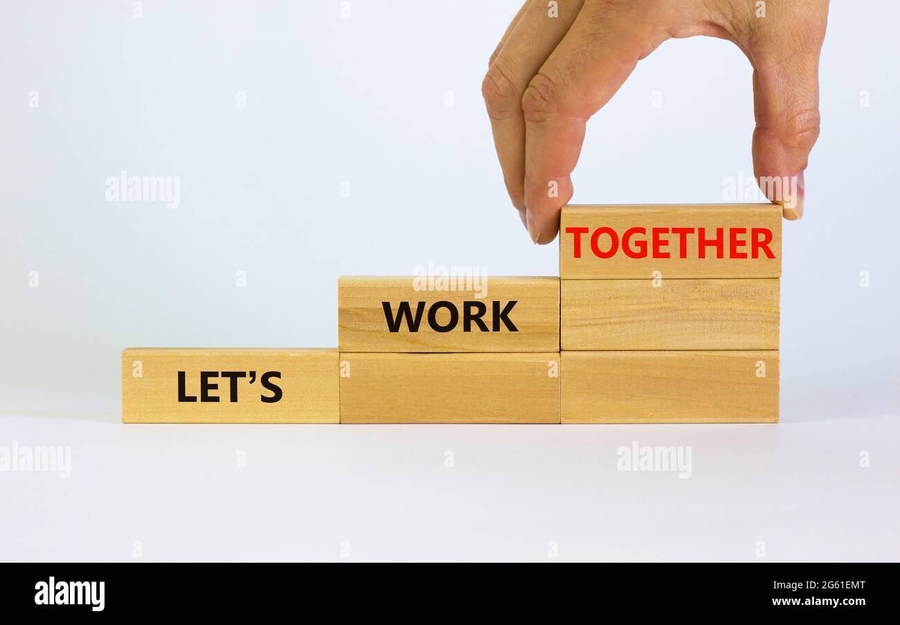 Work together symbol. Wooden blocks with words Let is work together on ...