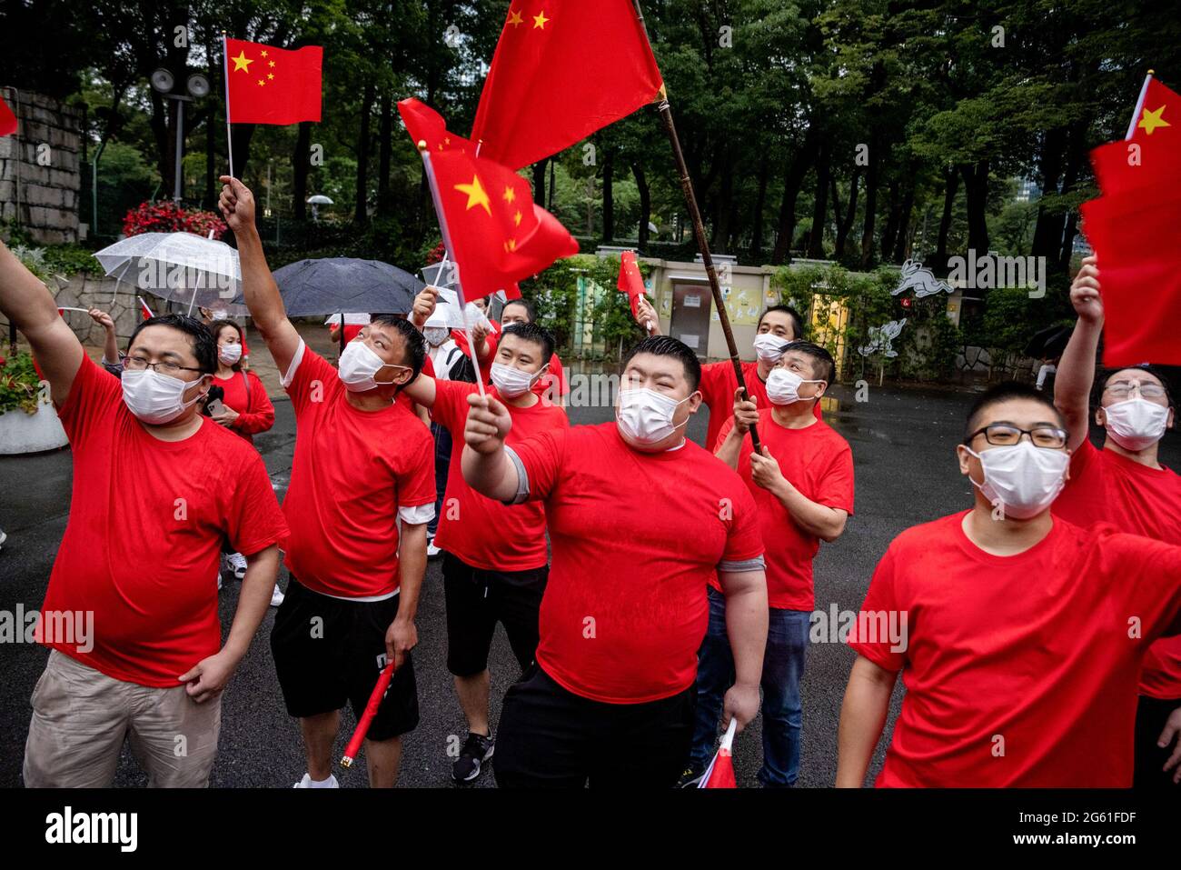Pro-Beijing supporters waving Chinese flags during a pro CCP rally.1st ...