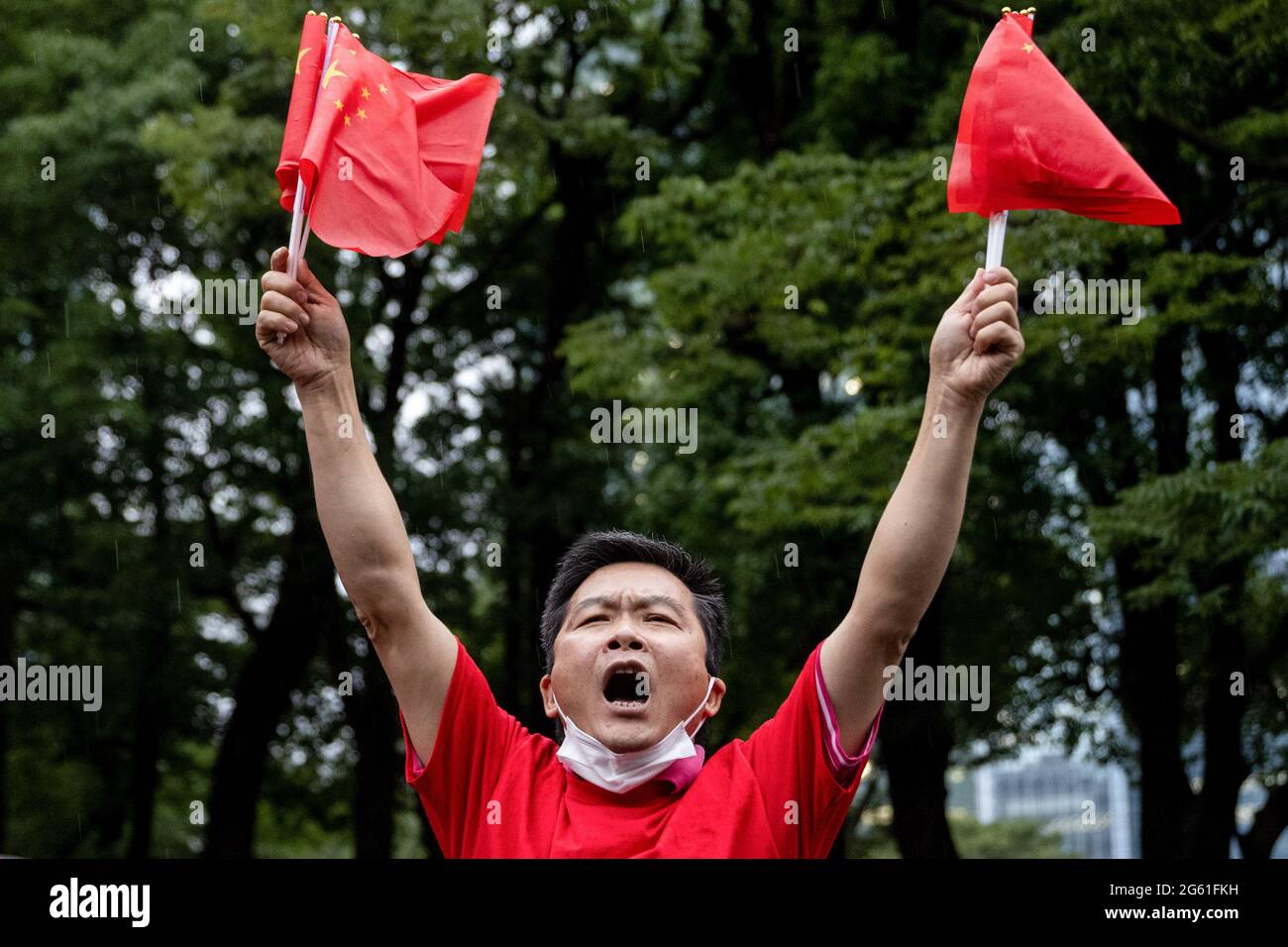 Tokyo, Japan. 01st July, 2021. A pro-Beijing supporter waving Chinese ...