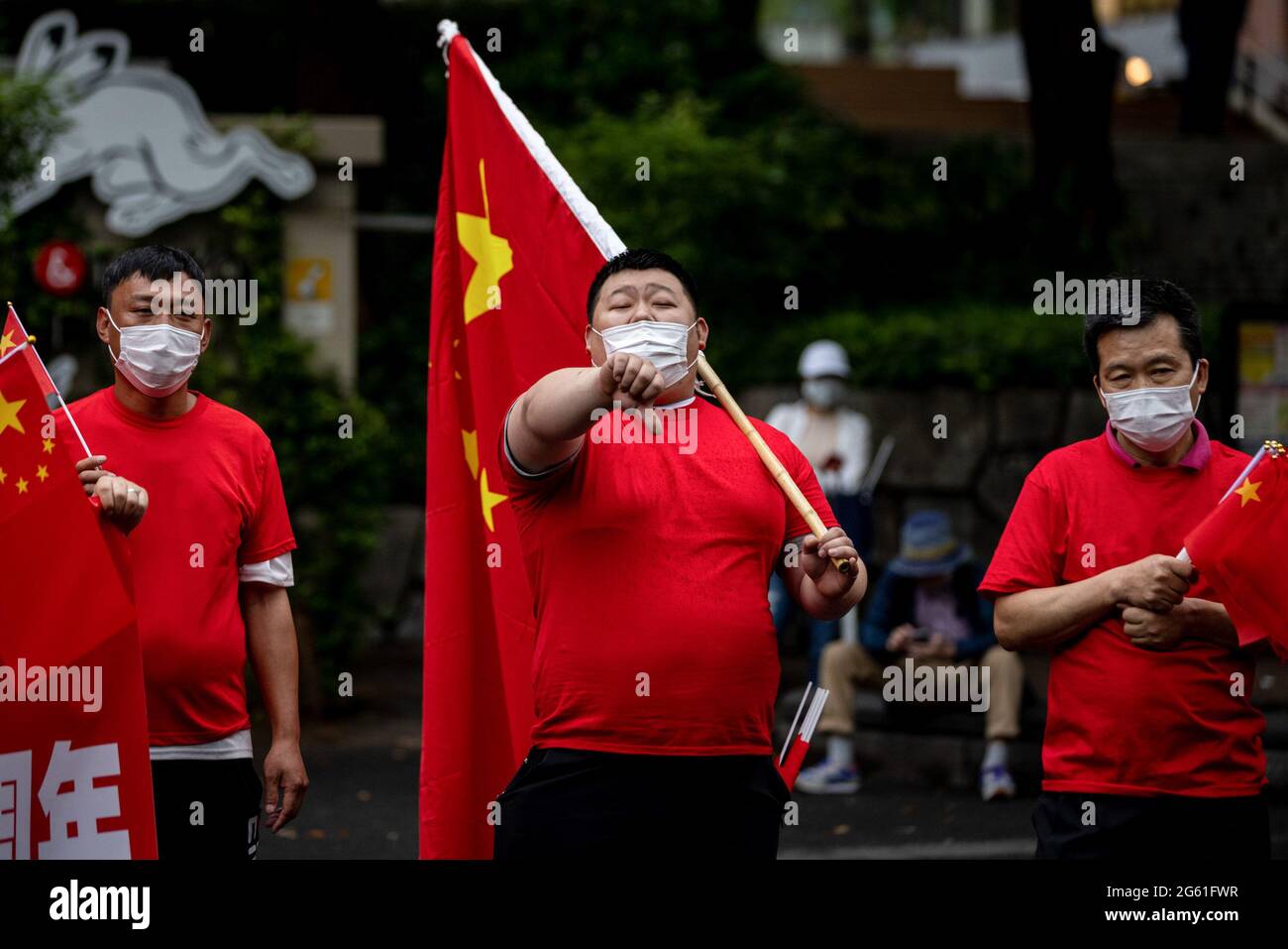 A pro-Beijing supporter with a Chinese flag gestures during a pro CCP ...