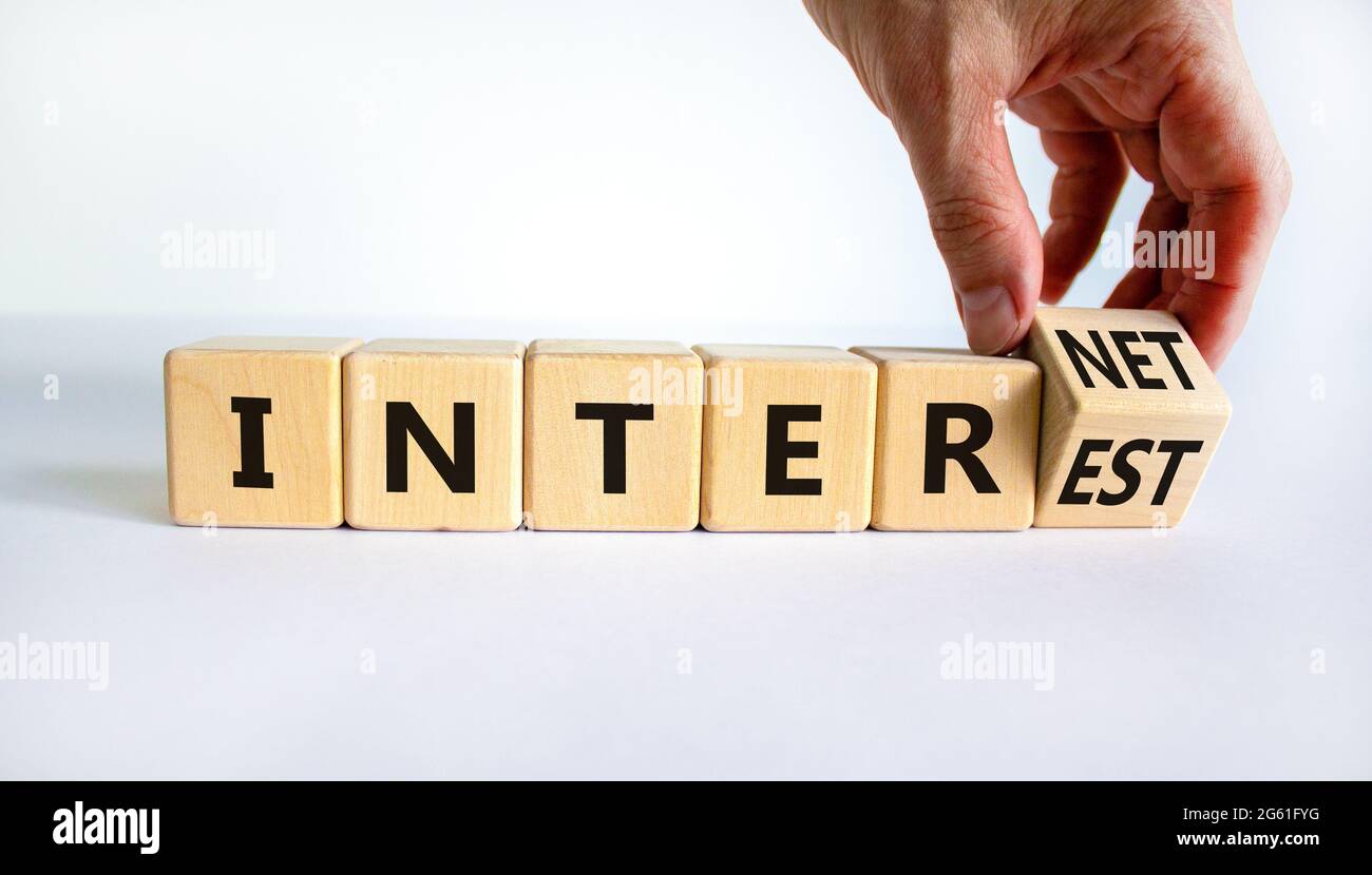 Internet and interest symbol. Businessman turns wooden cubes and ...