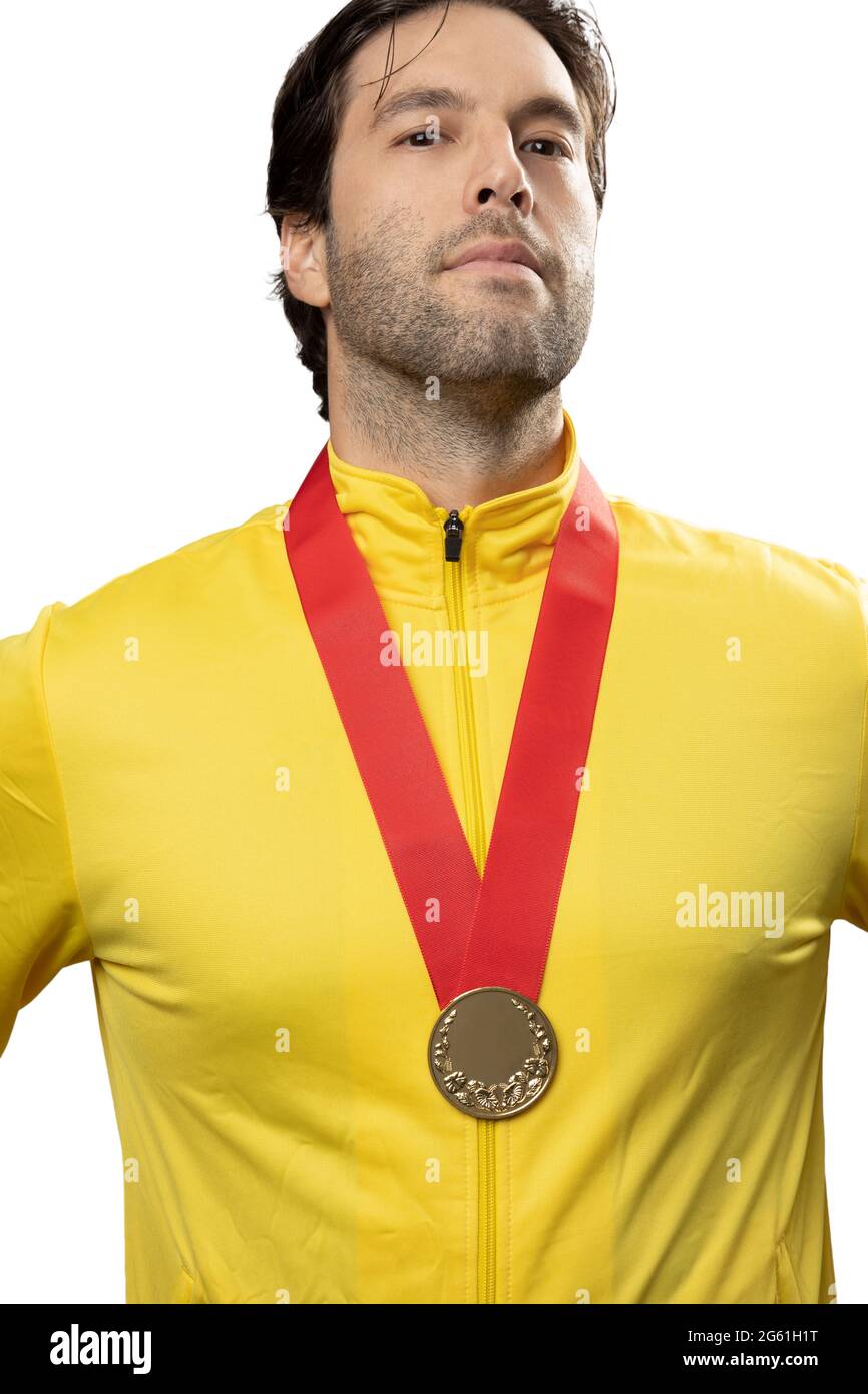 male athlete smiling after winning a gold medal in a white background ...