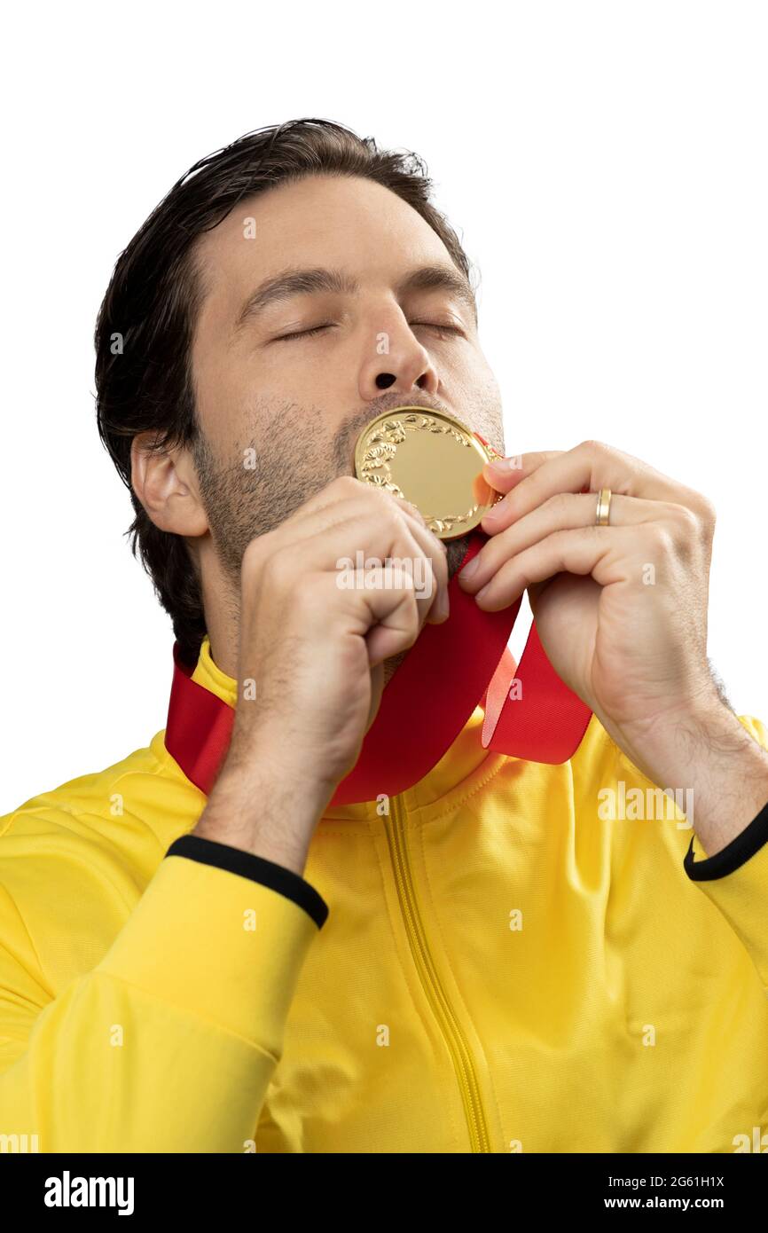 male athlete smiling after winning a gold medal in a white background ...