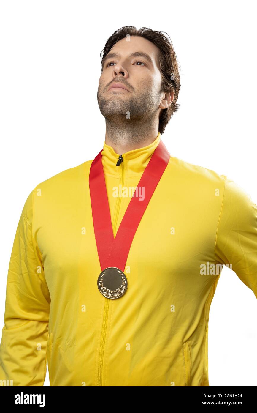 male athlete smiling after winning a gold medal in a white background ...