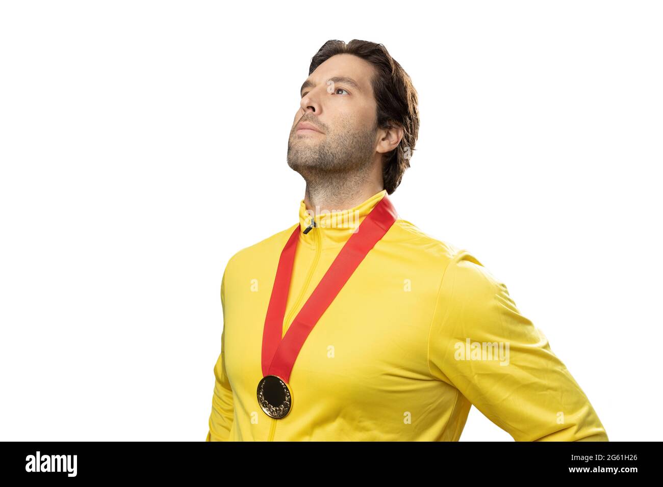 male athlete smiling after winning a gold medal in a white background ...