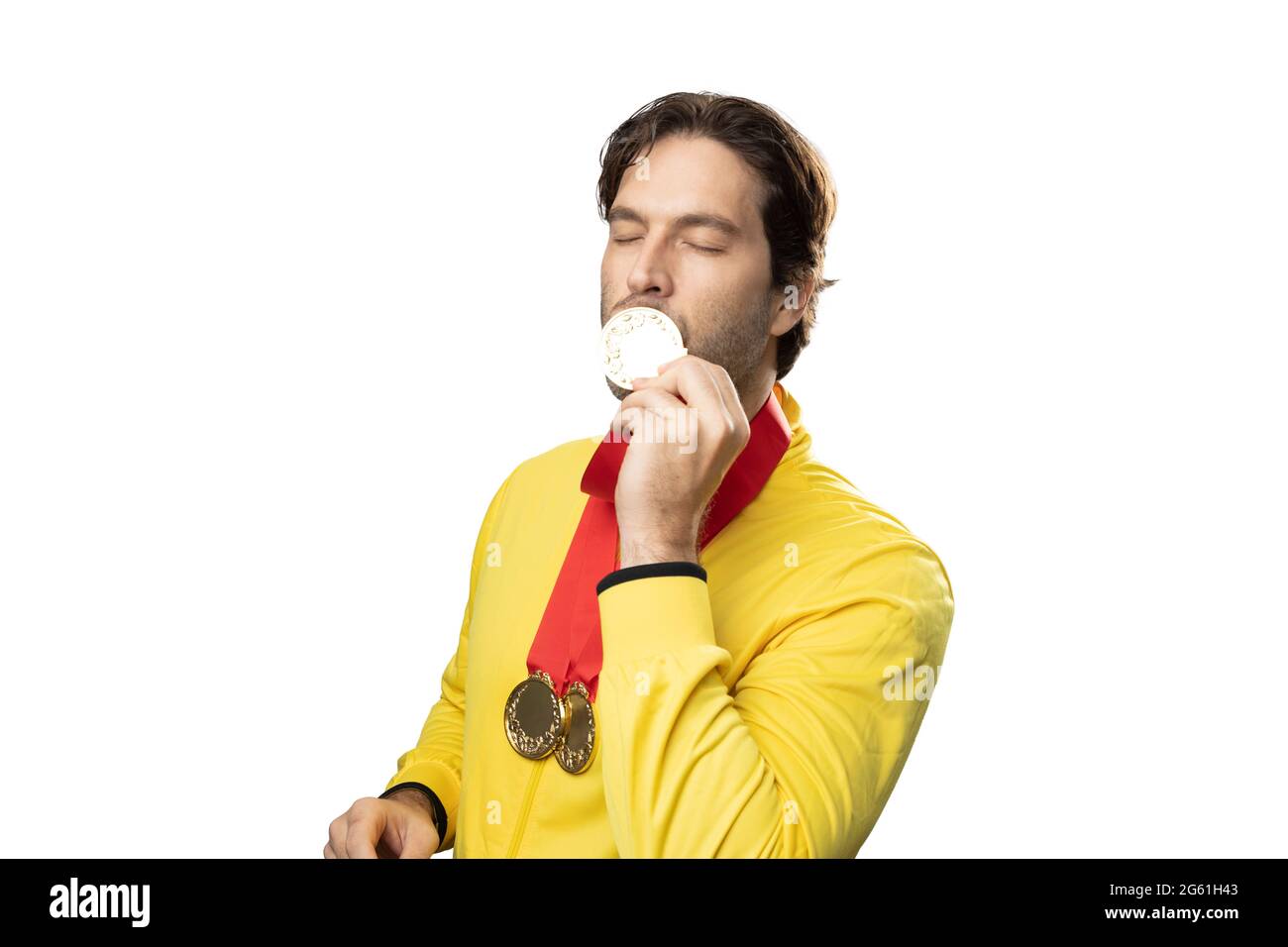 male athlete smiling after winning a gold medal in a white background ...