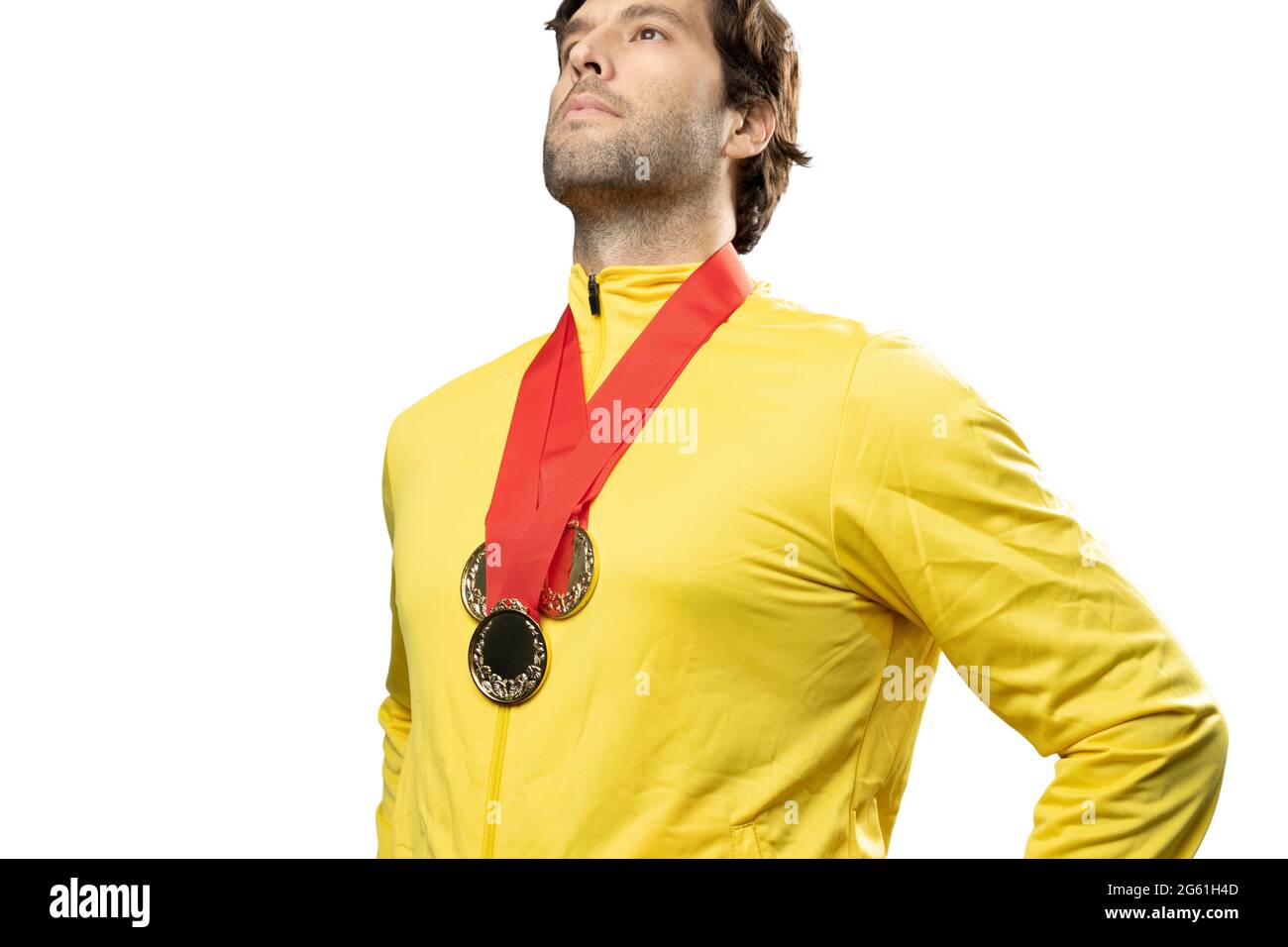 male athlete smiling after winning a gold medal in a white background ...