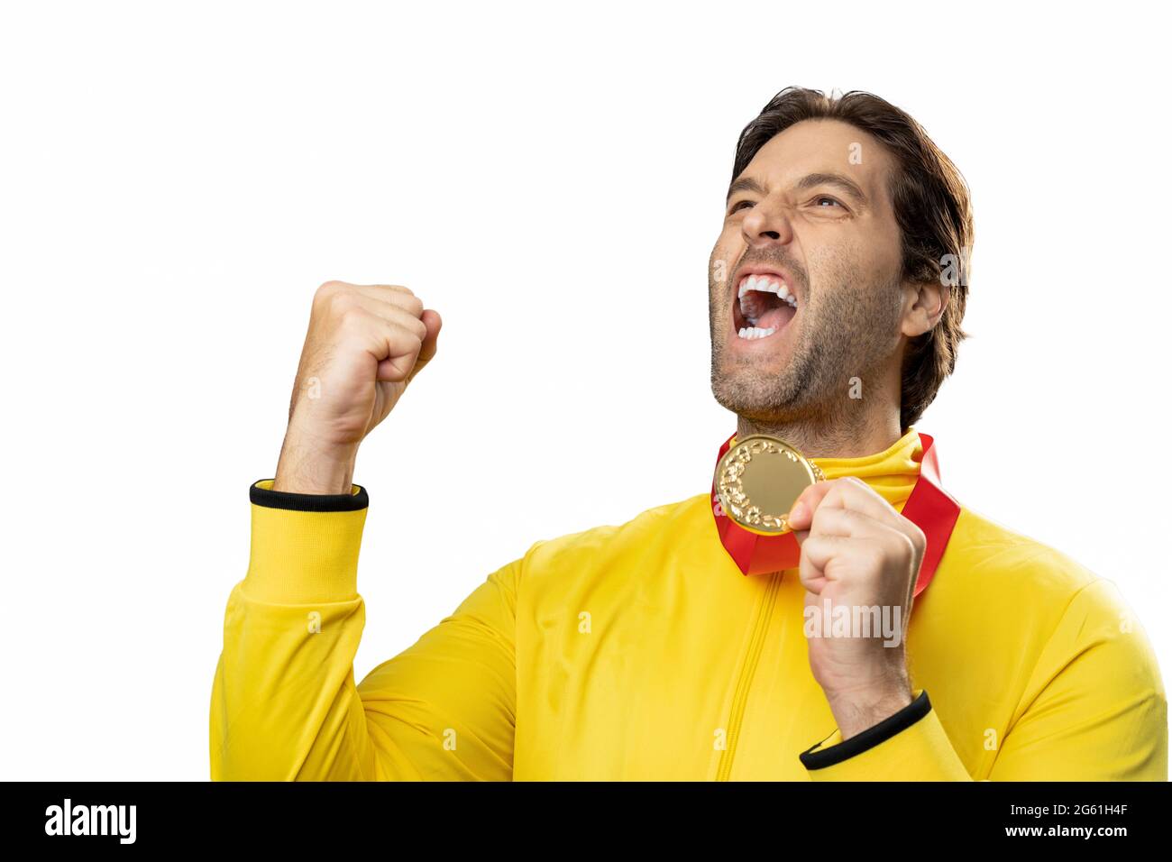 male athlete smiling after winning a gold medal in a white background ...