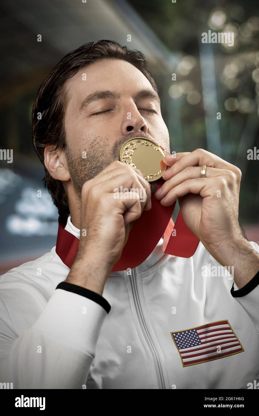 American male athlete smiling after winning a gold medal in a stadium ...