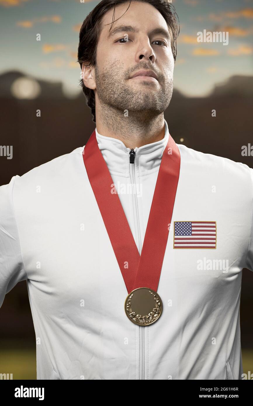American male athlete smiling after winning a gold medal in a stadium ...