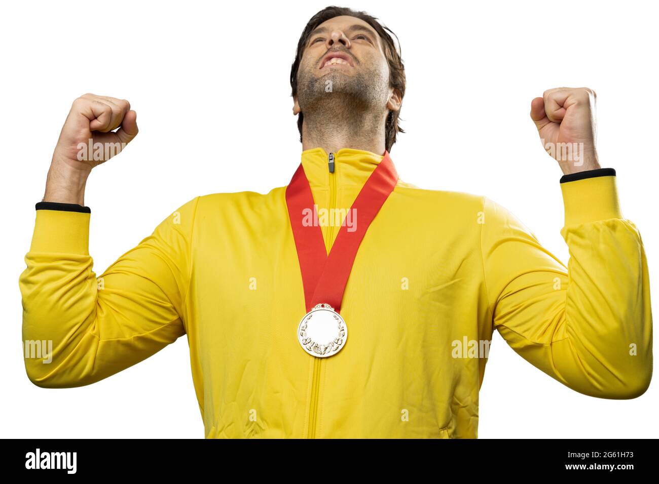 male athlete smiling after winning a gold medal in a white background ...