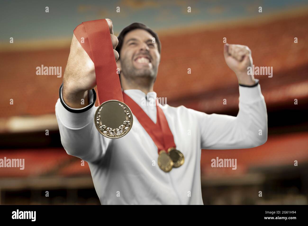 American male athlete smiling after winning a gold medal in a stadium ...