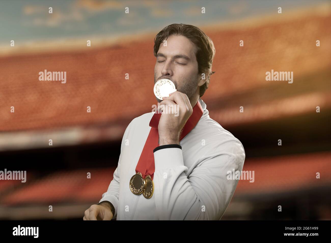 American male athlete smiling after winning a gold medal in a stadium ...