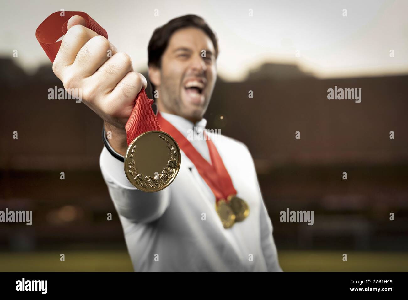American male athlete smiling after winning a gold medal in a stadium ...