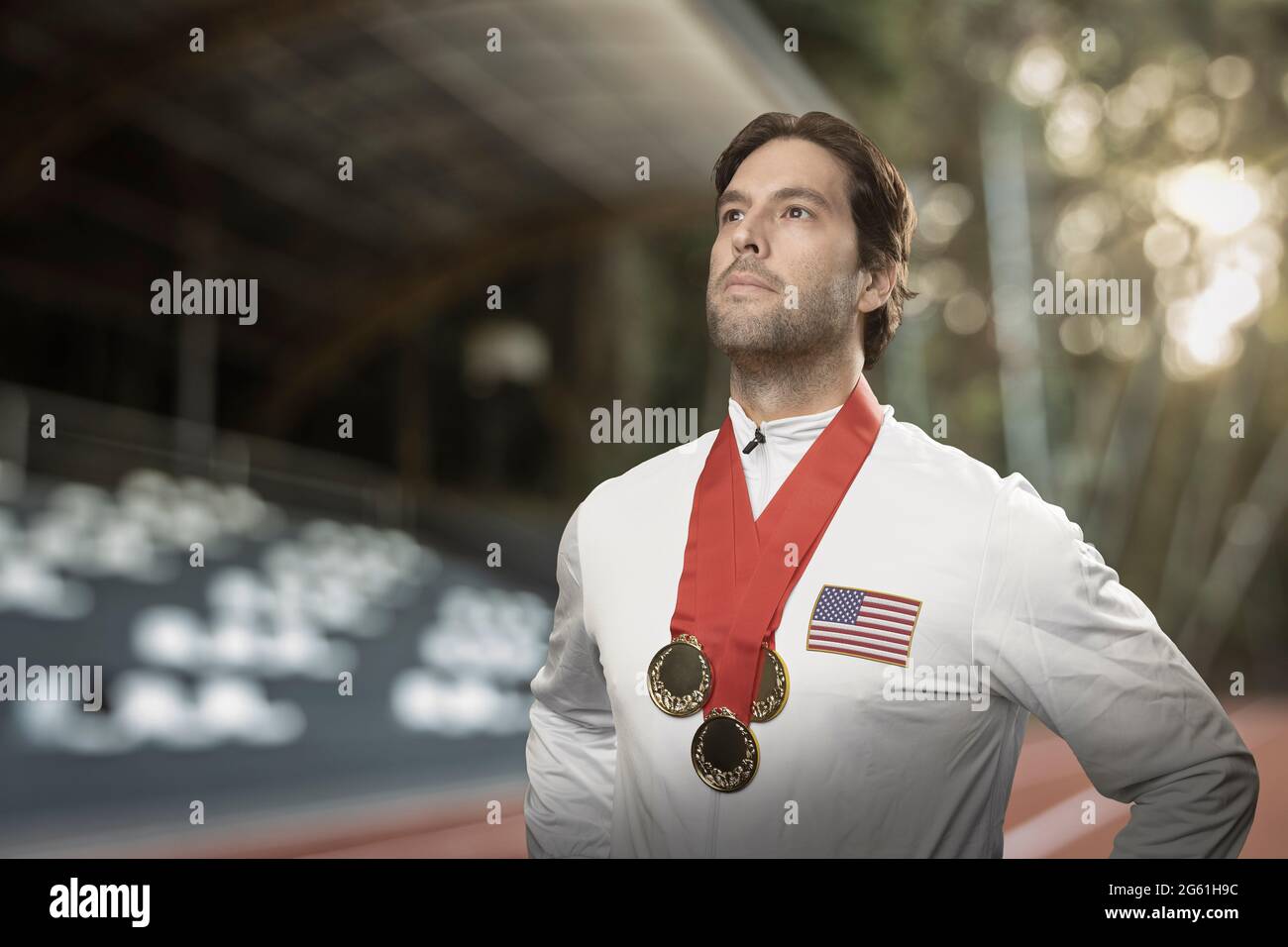 American male athlete smiling after winning a gold medal in a stadium ...