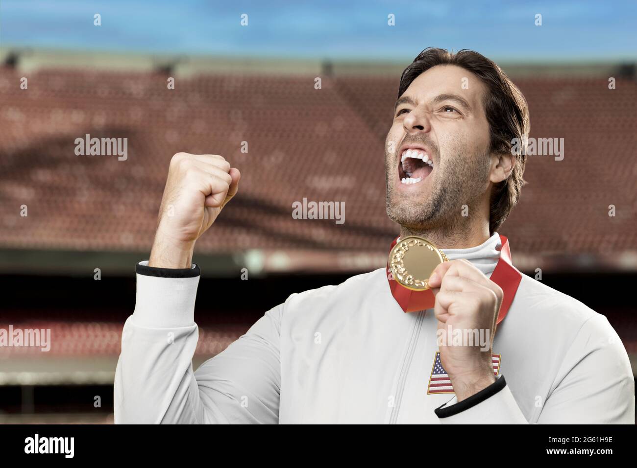 American male athlete smiling after winning a gold medal in a stadium ...
