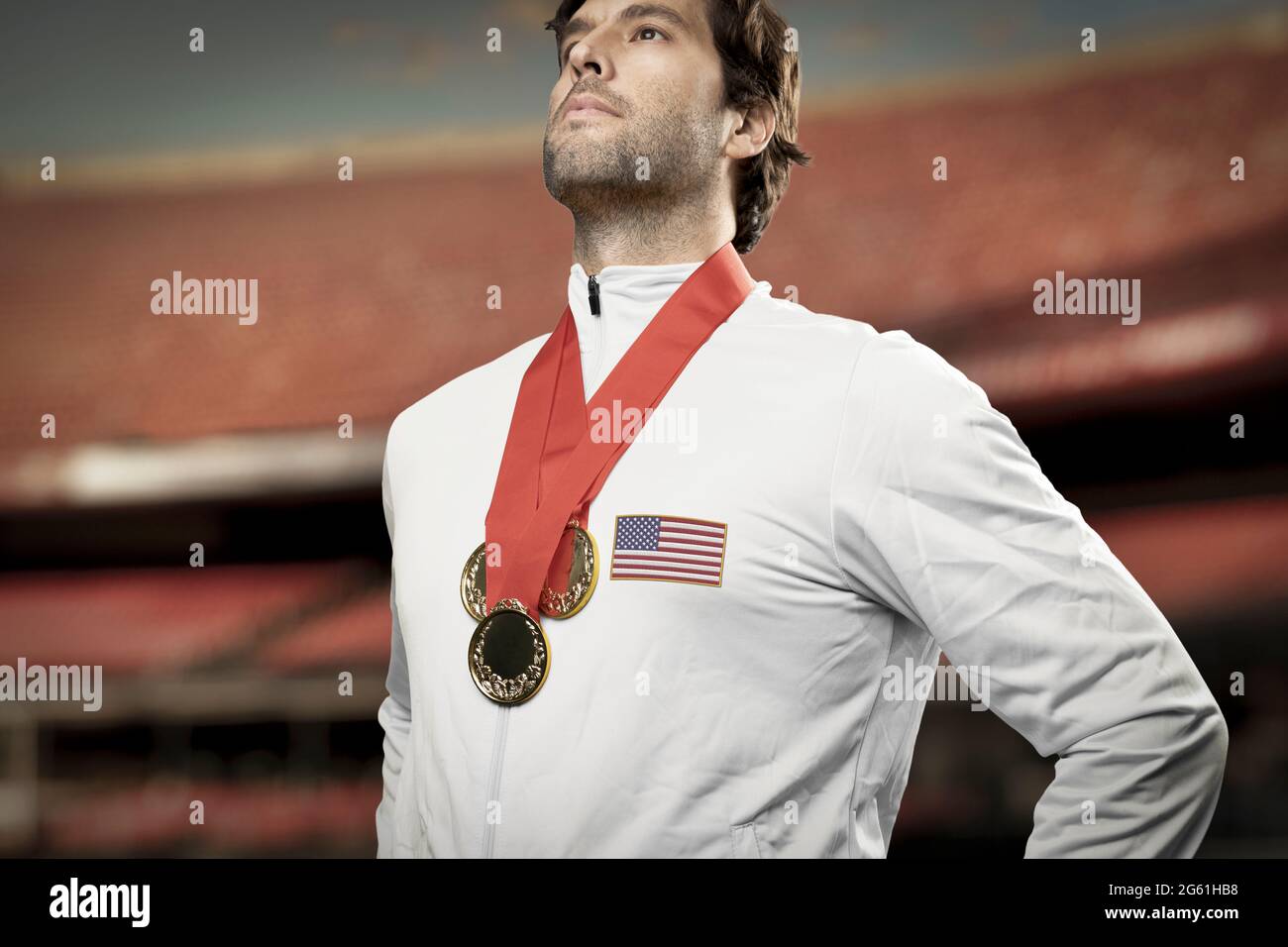 American male athlete smiling after winning a gold medal in a stadium ...